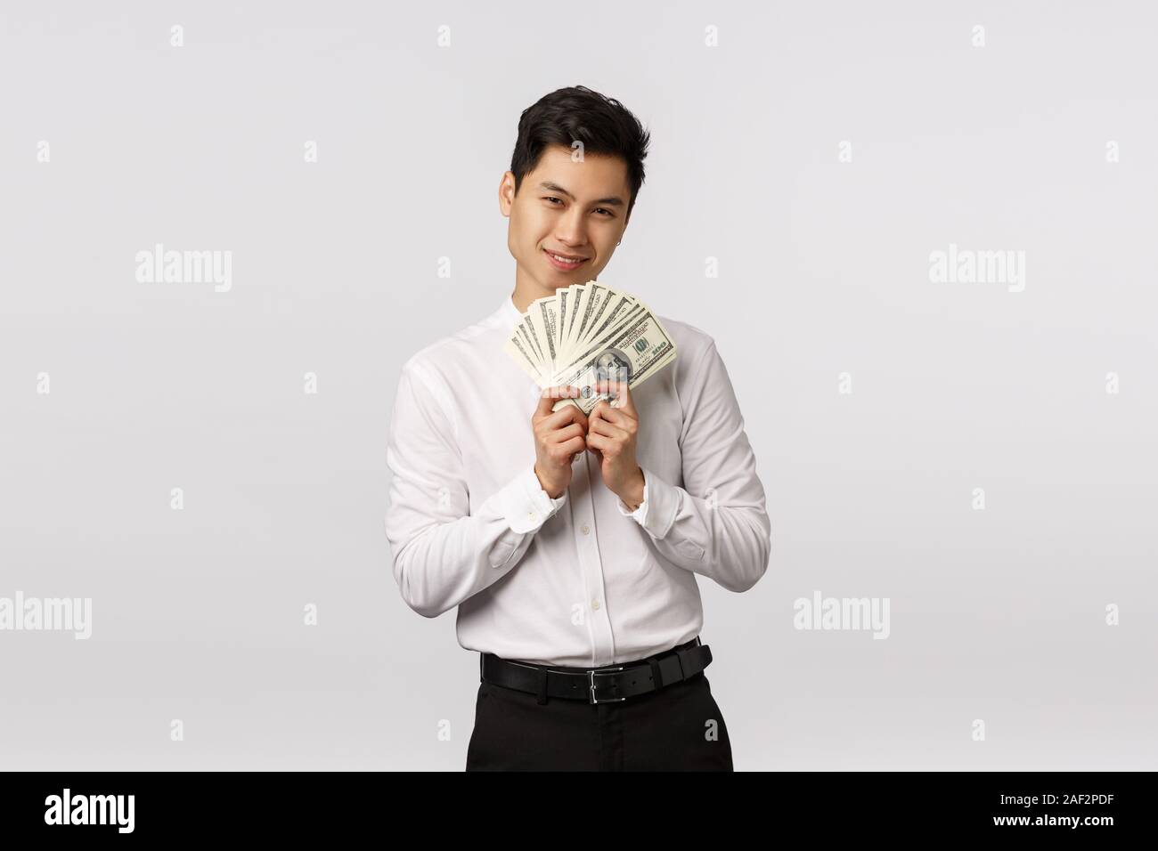 Young businessman holding big amount hi-res stock photography and ...