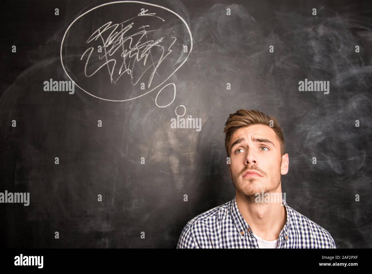 Portrait of young handsome man with confused expression of his face ...