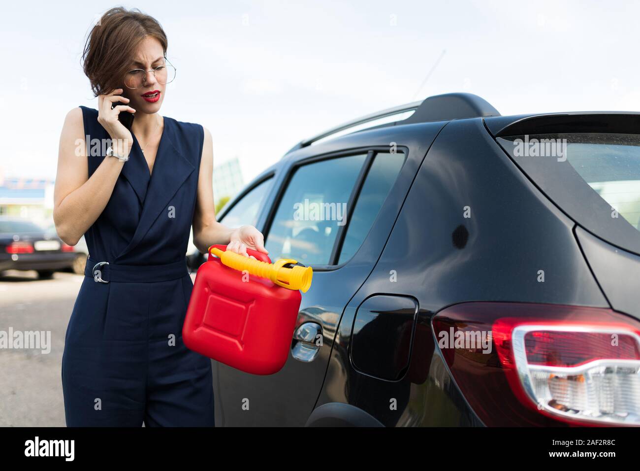 Beutiful woman in strict style of clothing gets out of the car for an ...