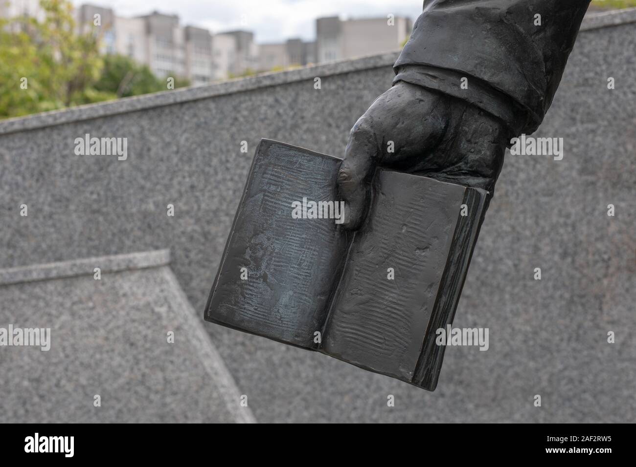Statue of a man holding book hi-res stock photography and images - Alamy