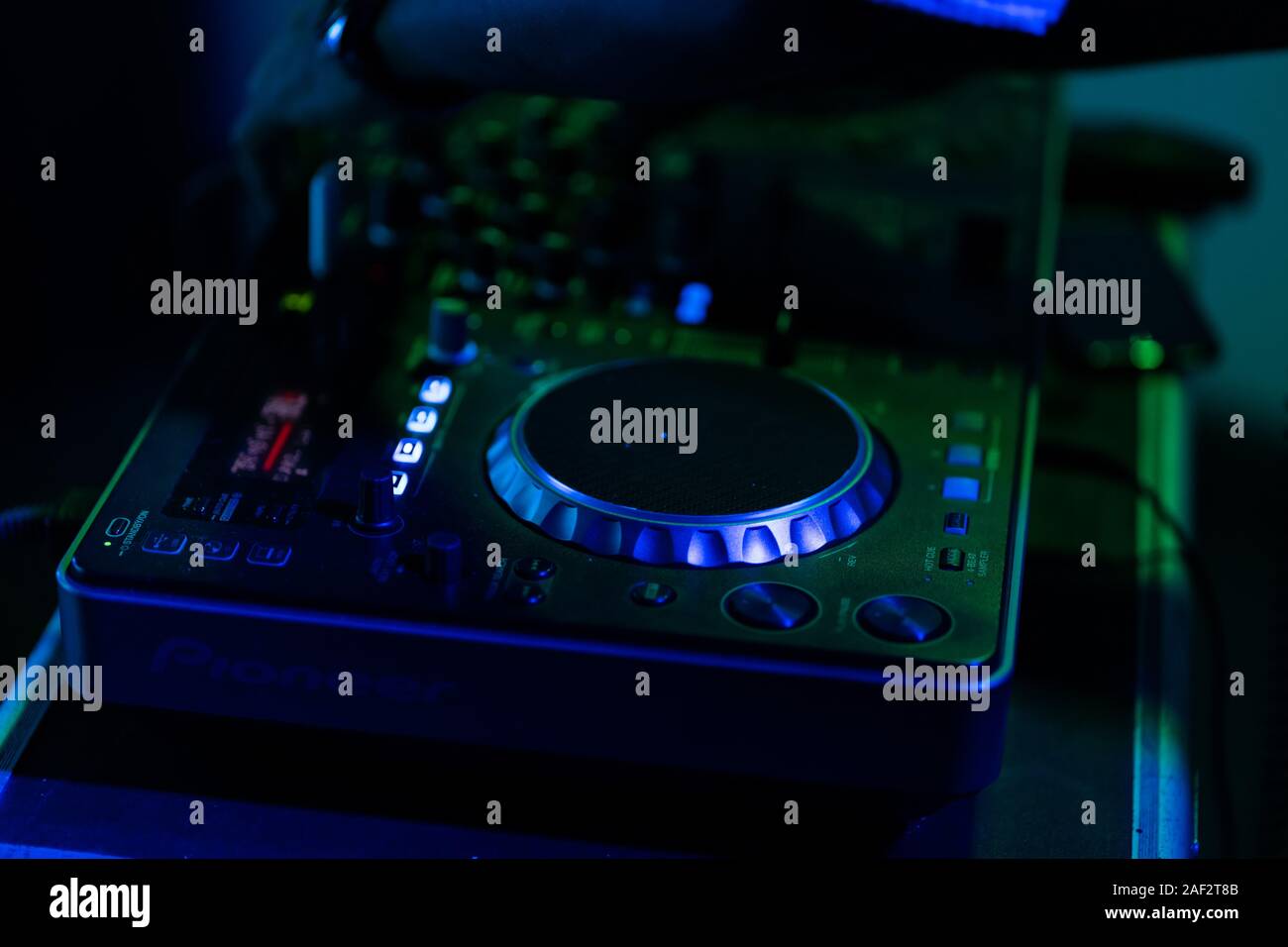 club dj plays music on stage in nightclub.Hand of disc jockey adjusting ...