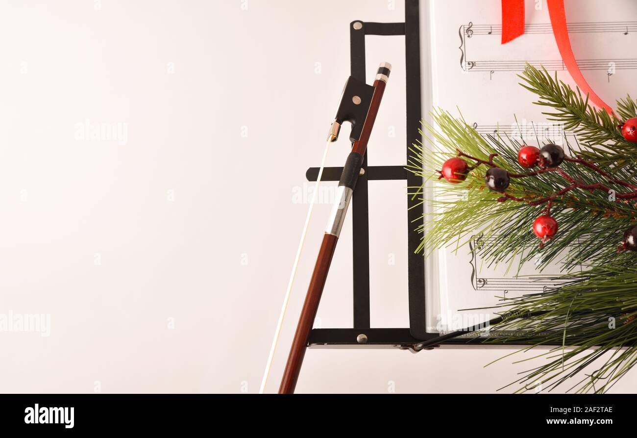 Christmas concert concept with bow and music stand white background ...