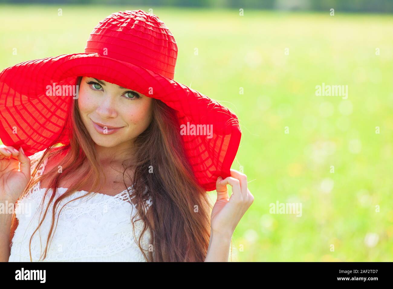 Pretty girl wearing red hat posing outdoors Stock Photo - Alamy