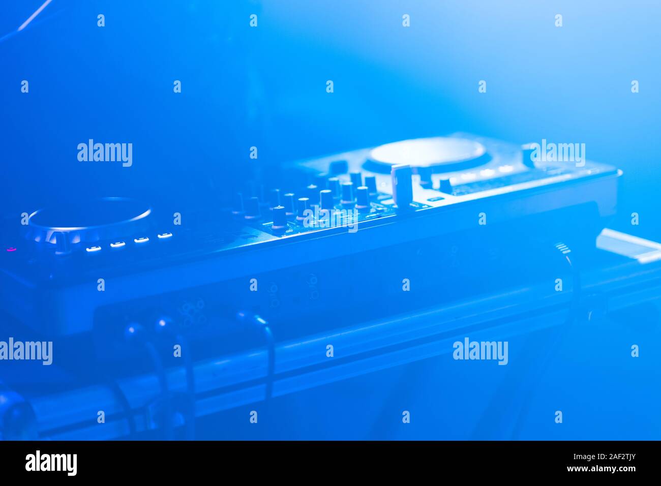 club dj plays music on stage in nightclub.Hand of disc jockey adjusting ...