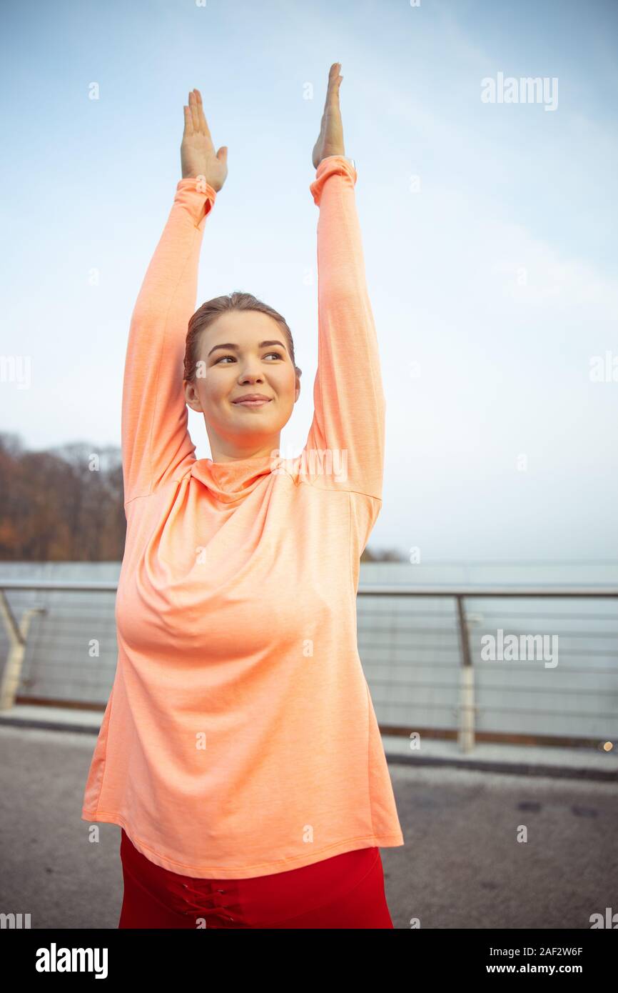 Beautiful smiling lady doing morning gymnastics outdoors Stock Photo ...