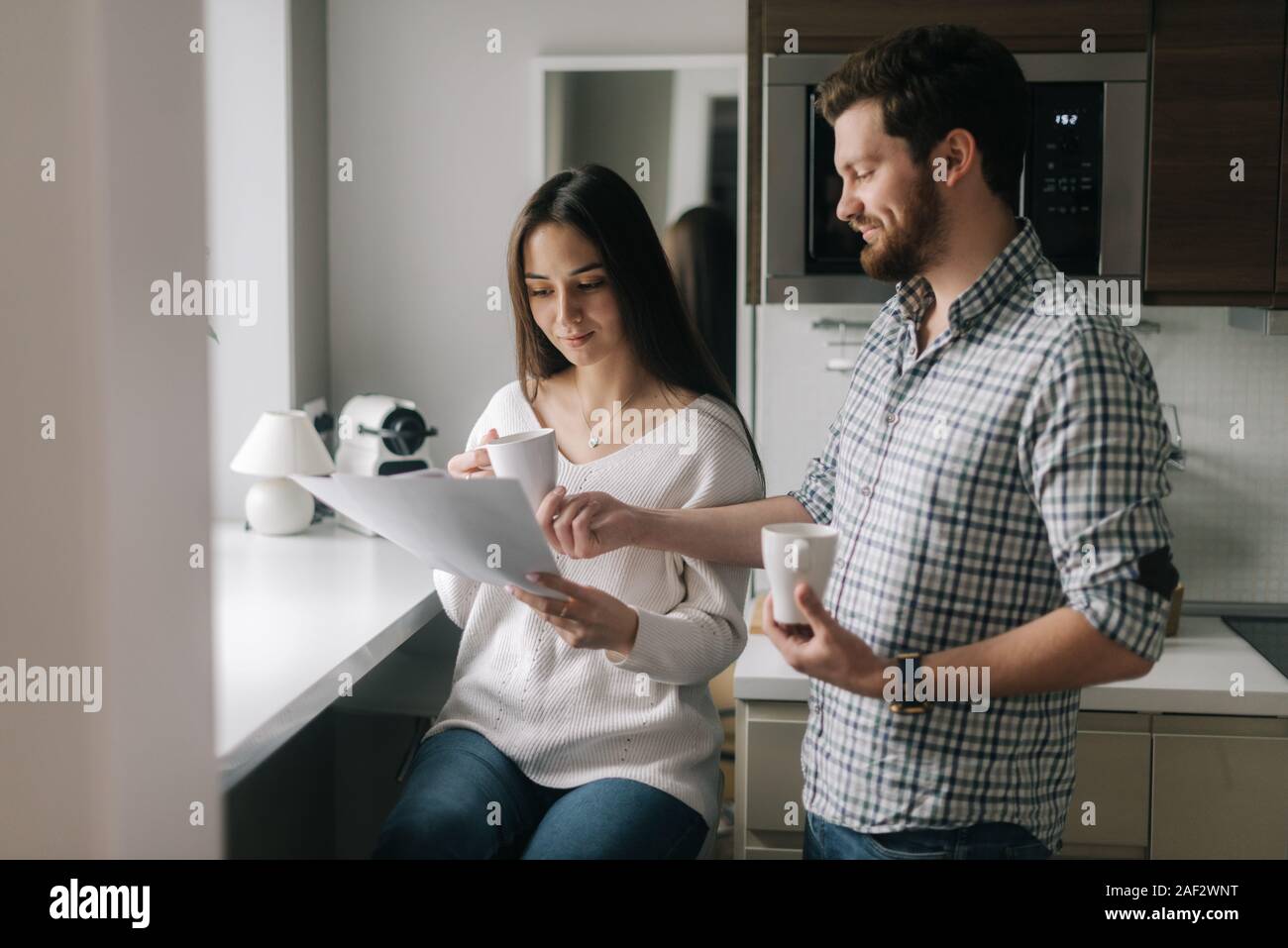 Beautiful couple is reading documents Stock Photo - Alamy