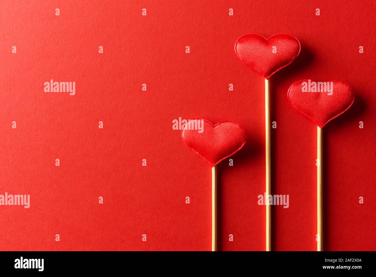 Red textile hearts on wooden sticks closeup. Valentines day background ...