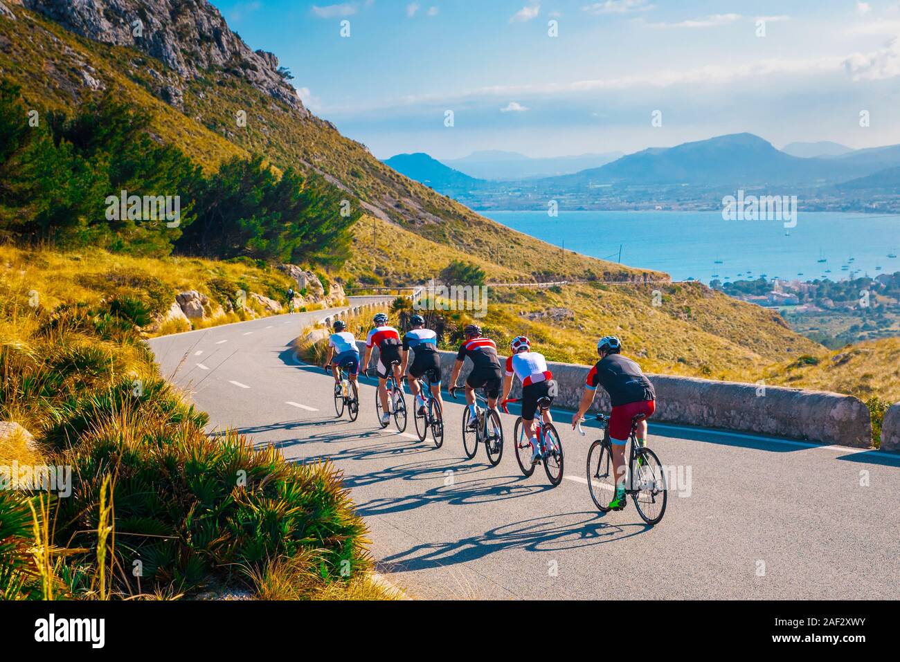 Sporty friends on bicycle on sunset light in beautiful nature by the ...