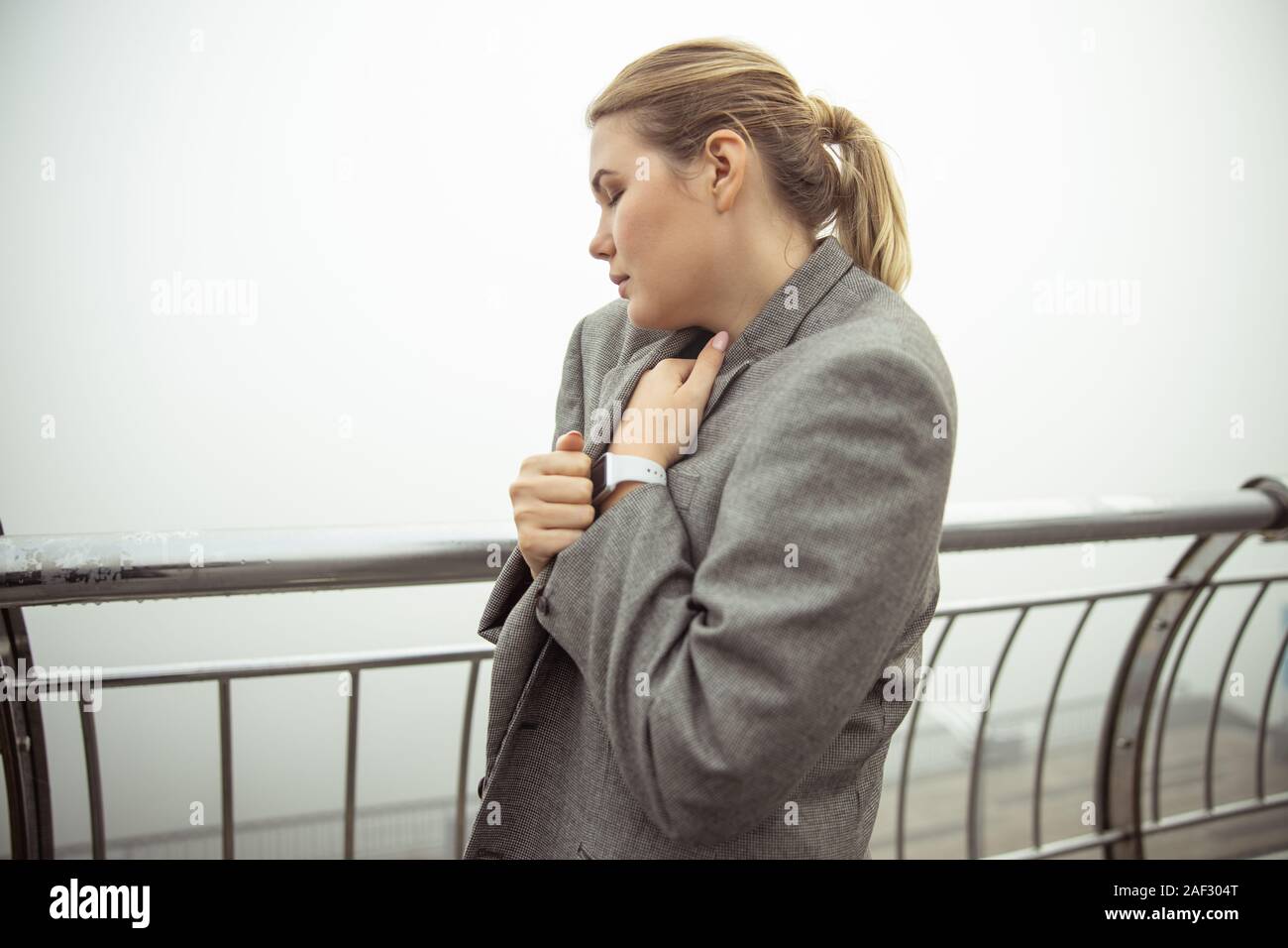Beautiful calm lady in jacket standing on the street Stock Photo - Alamy