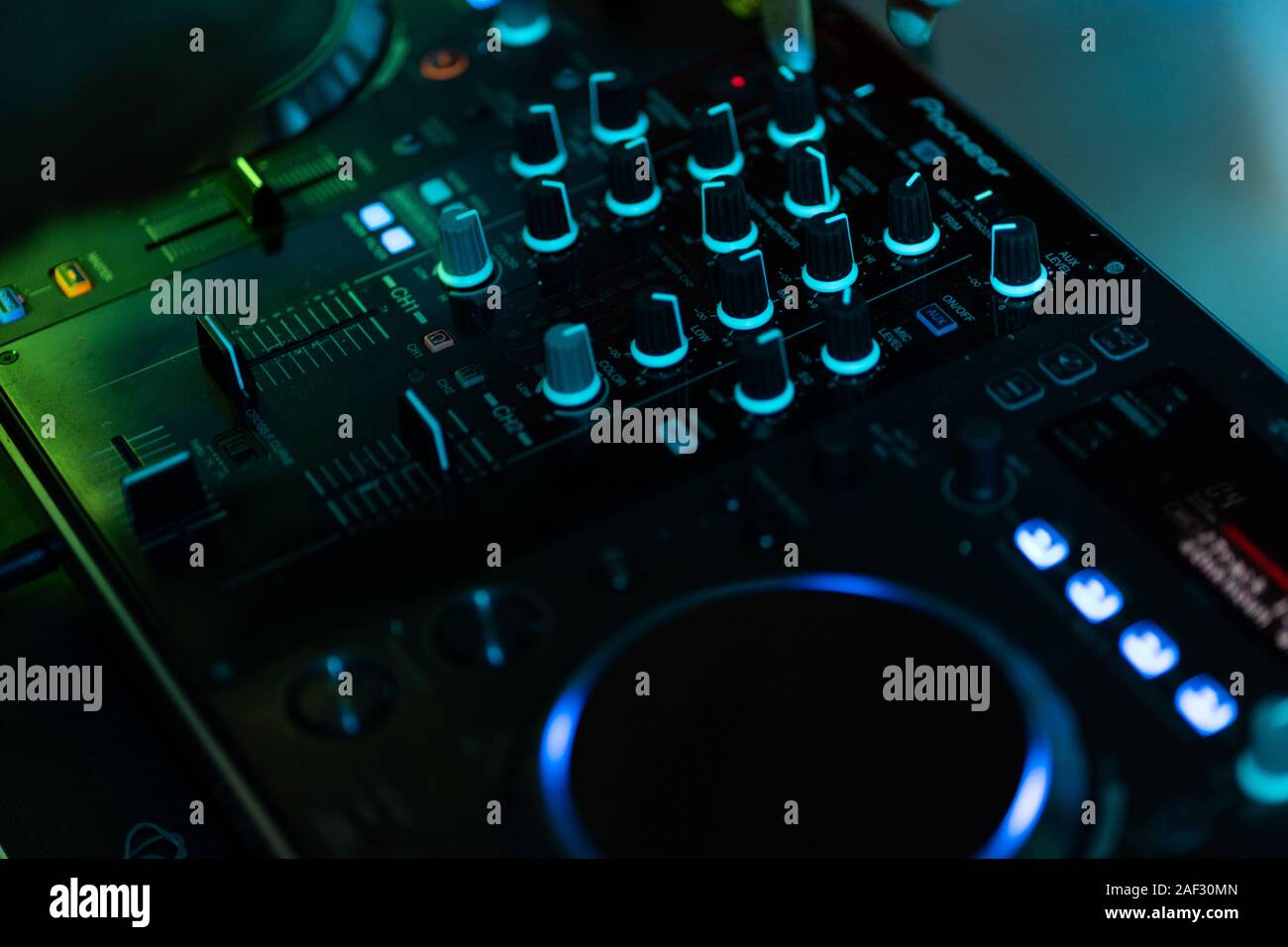 club dj plays music on stage in nightclub.Hand of disc jockey adjusting ...