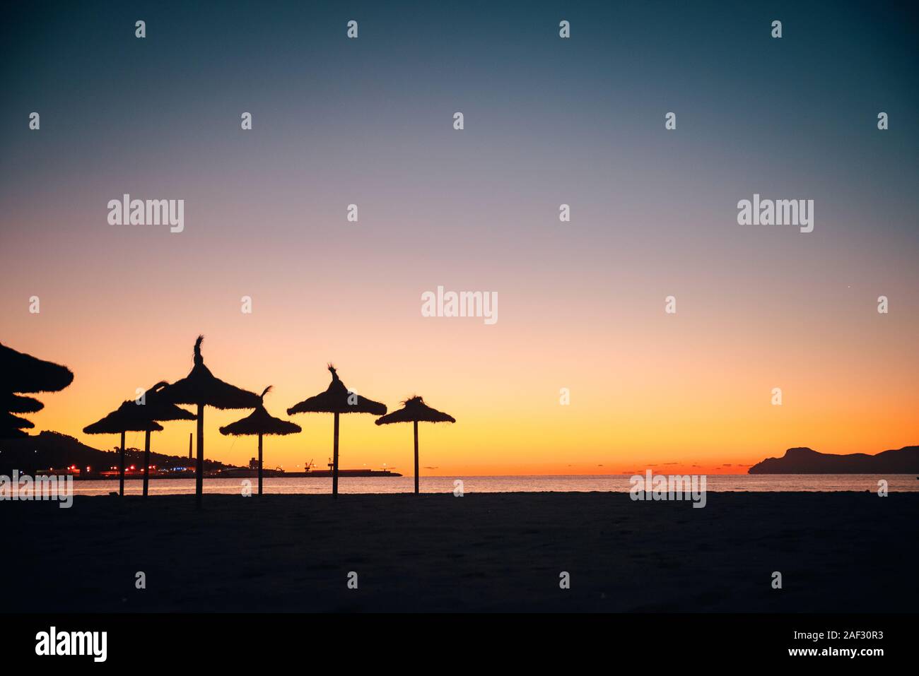 Straw Umbrellas Silhouette On A Tropical Beach Stock Photo Alamy Straw Umbrellas Silhouette On A Tropical Beach Stock Photo Alamy