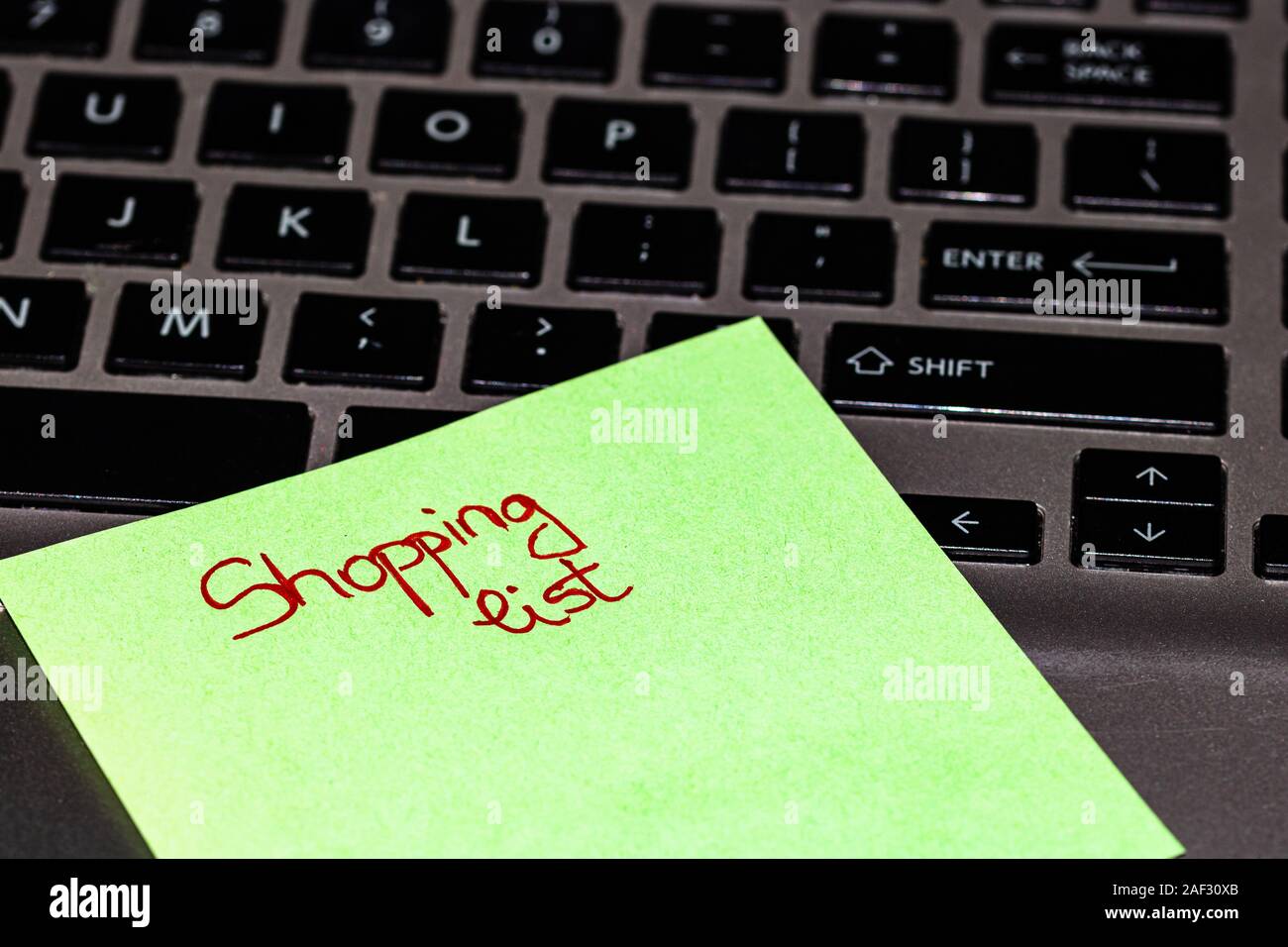 Writing on colorful sticky note Shopping list. Text with Shopping list ...