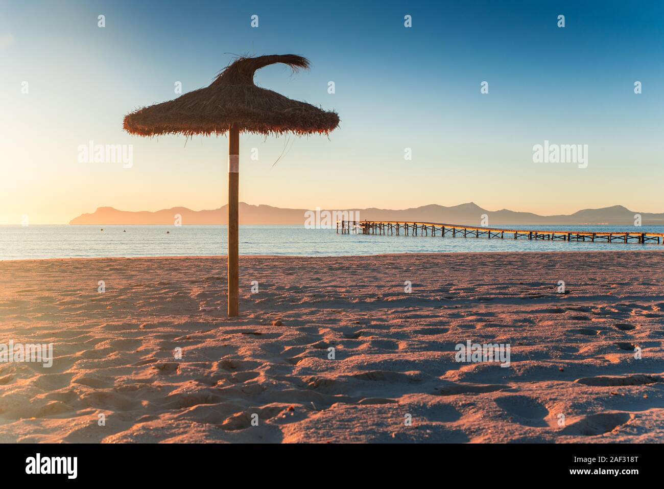 Umbrella on the beach Playa de Muro. Morning in summer vacation resort ...