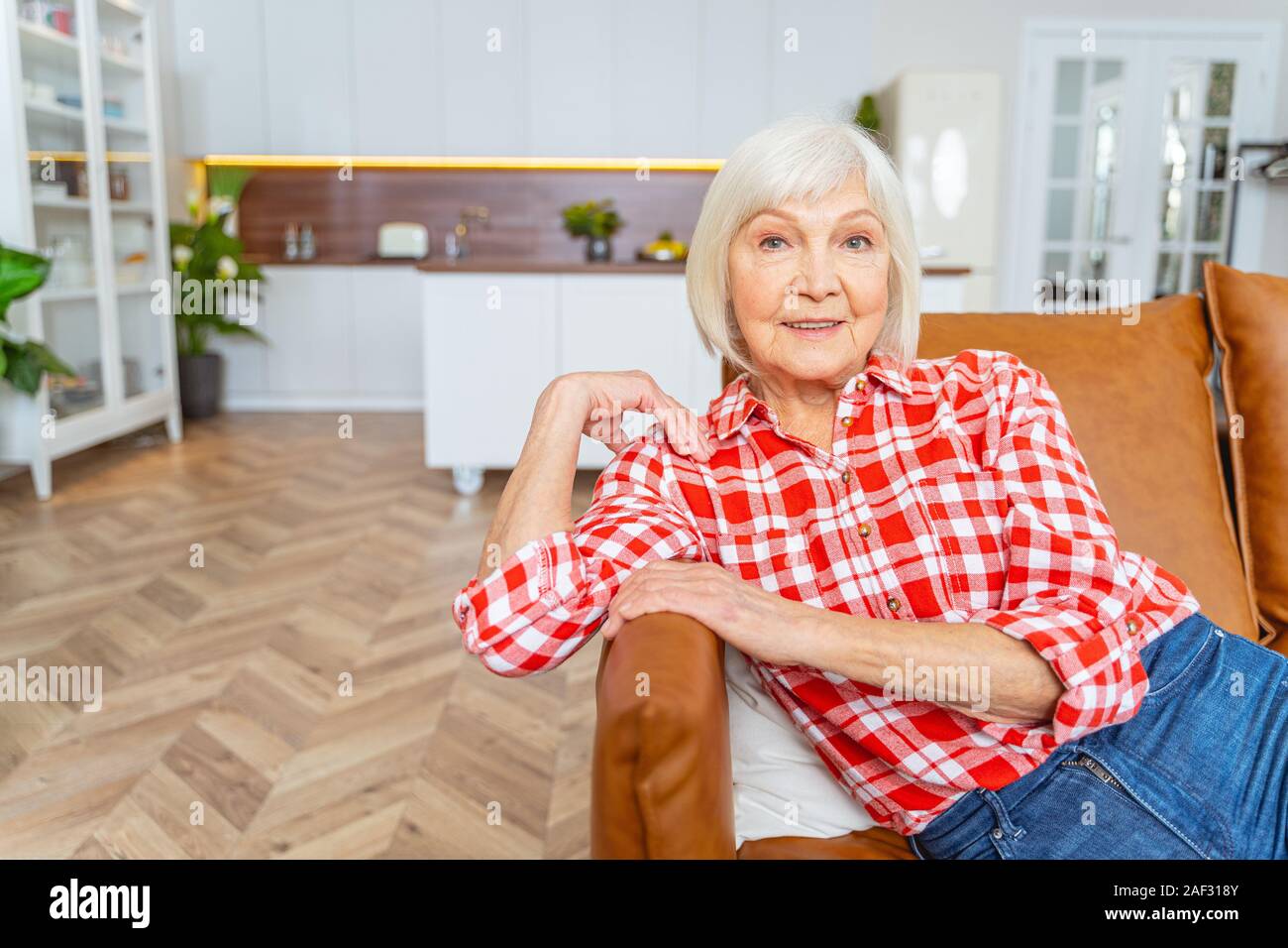 Woman reclining on leather couch hi-res stock photography and images ...