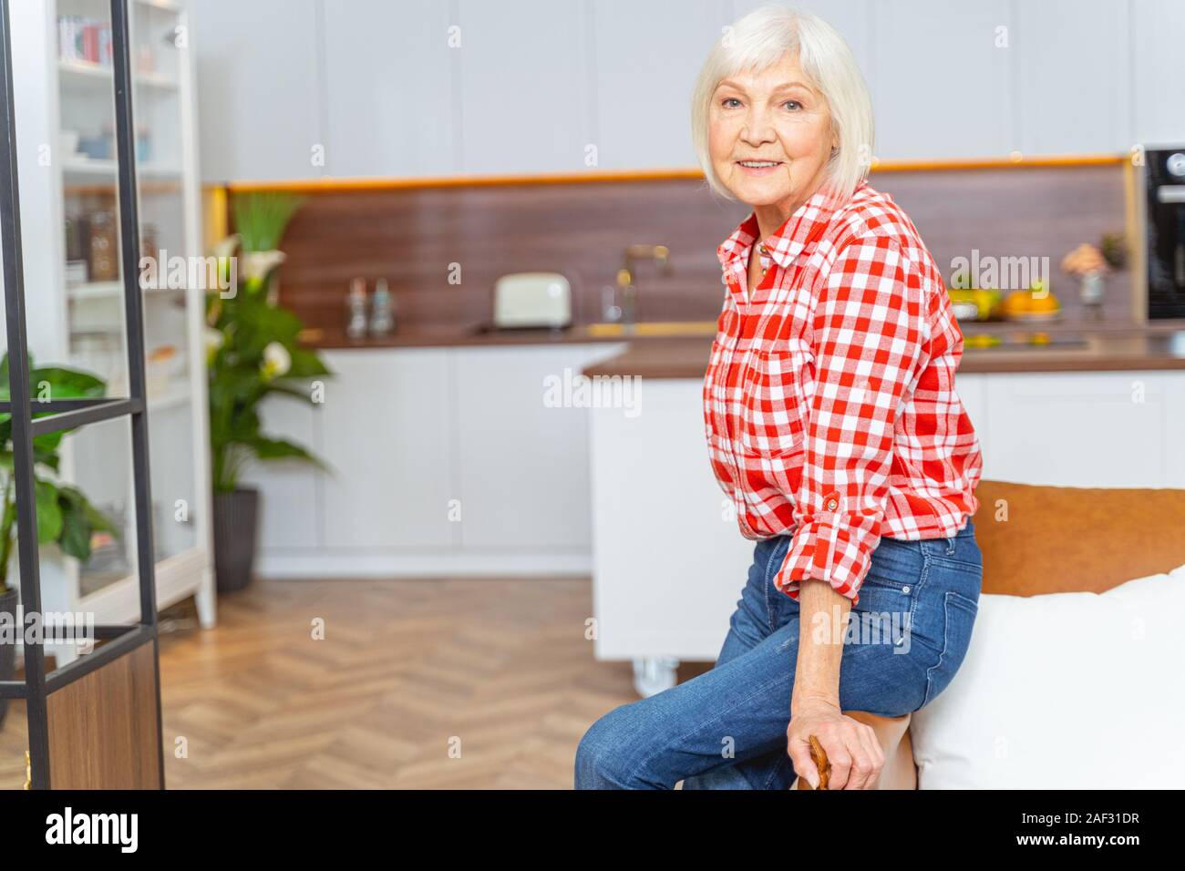 Joyous senior lady smiling at the camera Stock Photo - Alamy