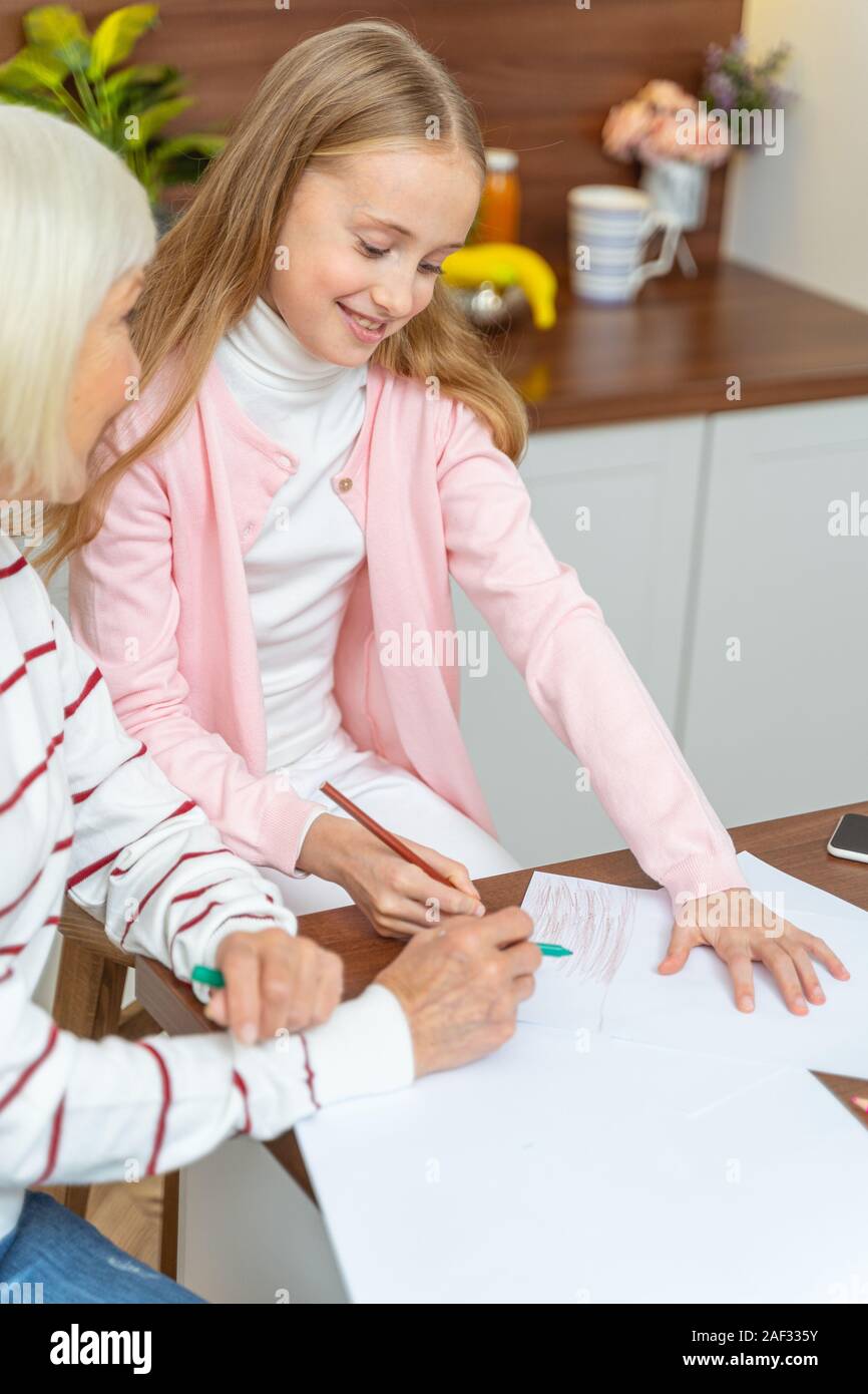 Kid looking at a sheet of paper Stock Photo - Alamy