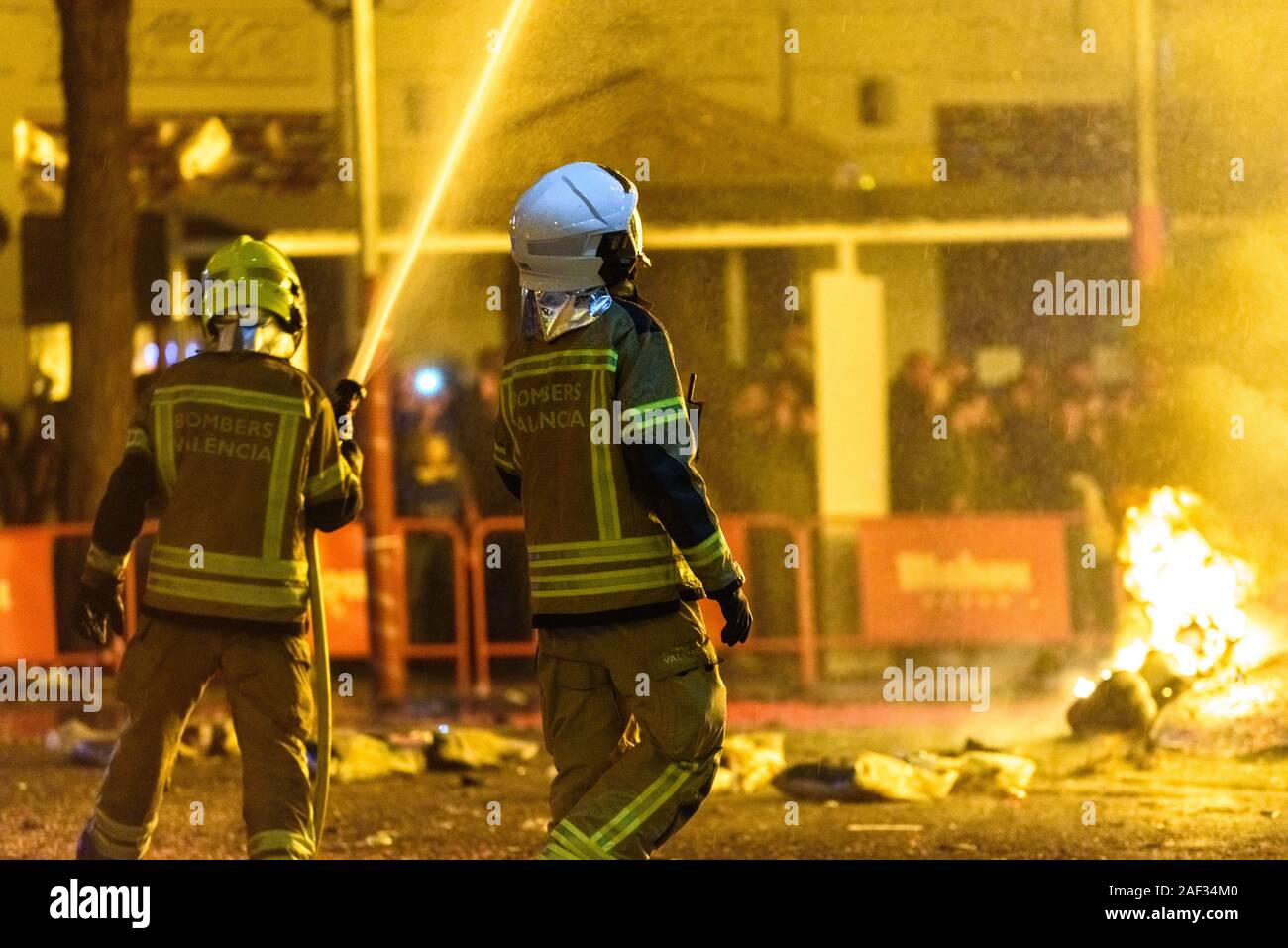 Firefighter with his protective suit working controlling the burning of ...