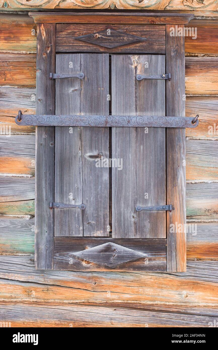 Rustic wooden window closed with shutters Stock Photo - Alamy