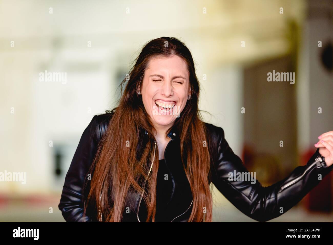 Young woman laughing loudly Stock Photo - Alamy