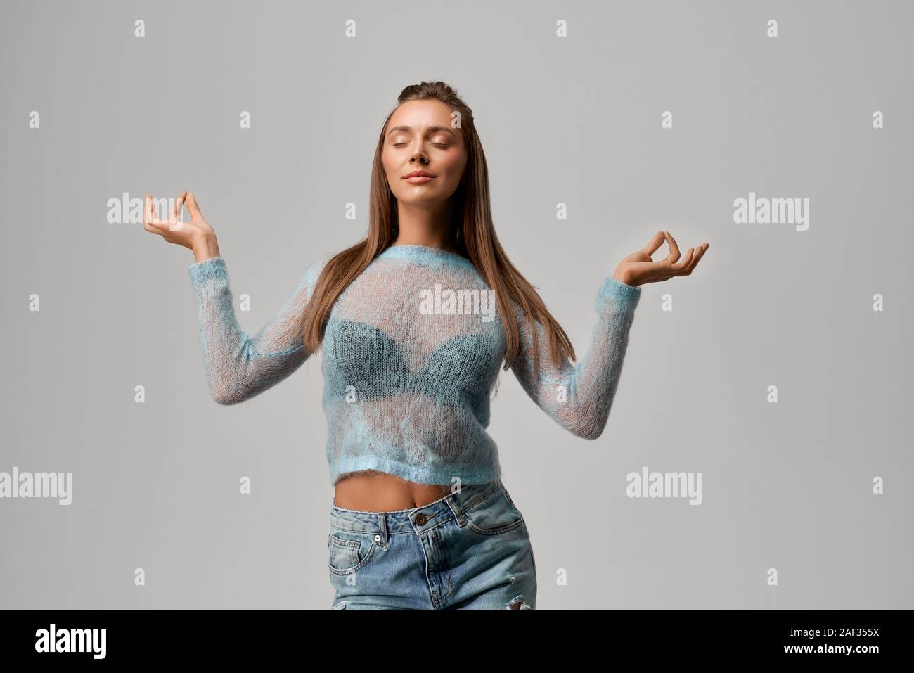 Crop portrait of girl showing peace using yoga pose. Gorgeous young ...