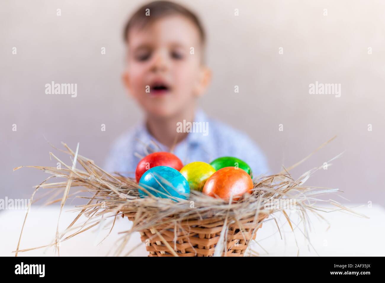 A handsome cute little boy looks with interest and curiosity at a ...