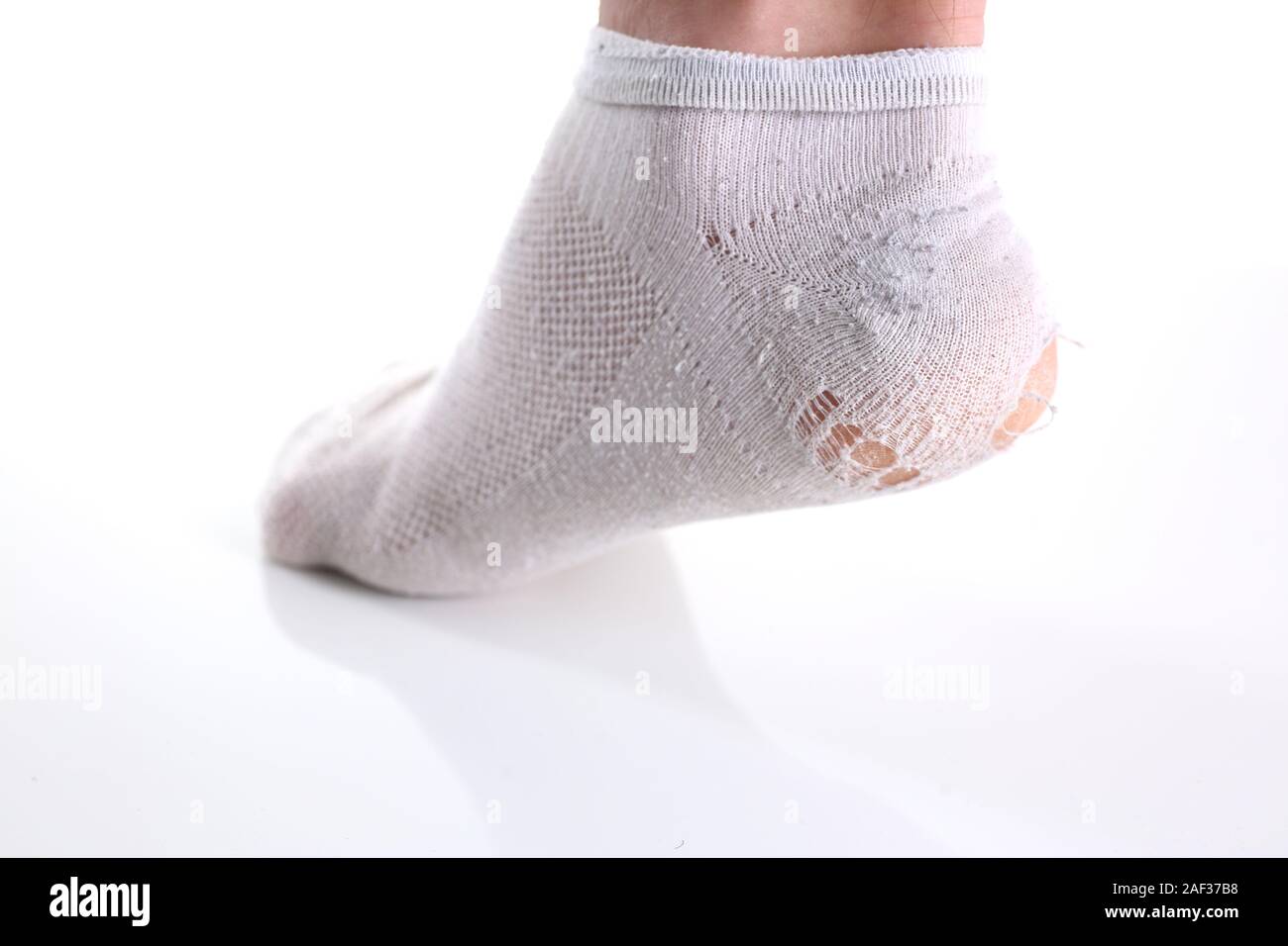 Ripped white sock on male leg isolated Stock Photo - Alamy
