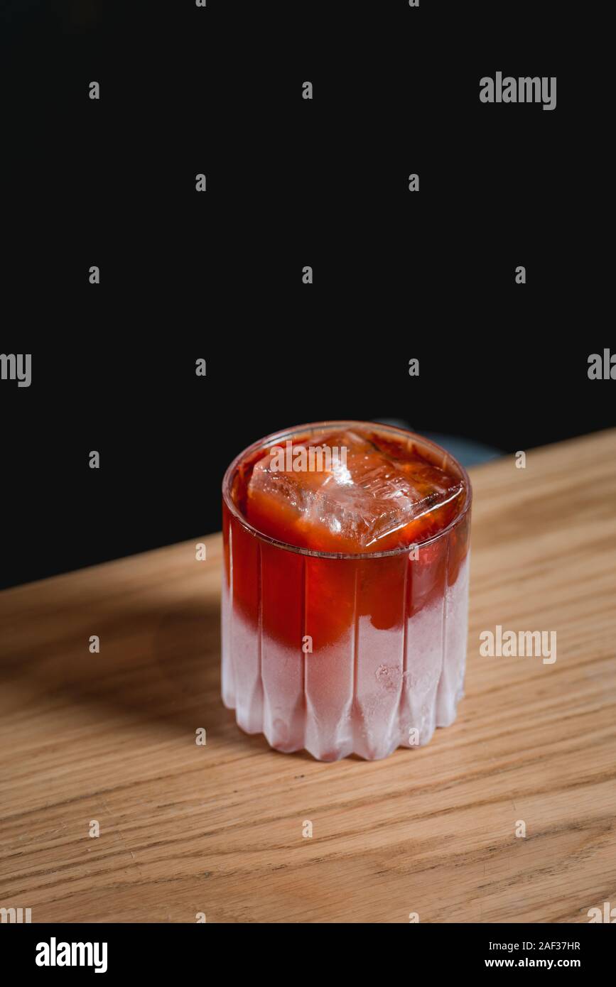 Boulevardie cocktail on a bar desk. Black background Stock Photo - Alamy