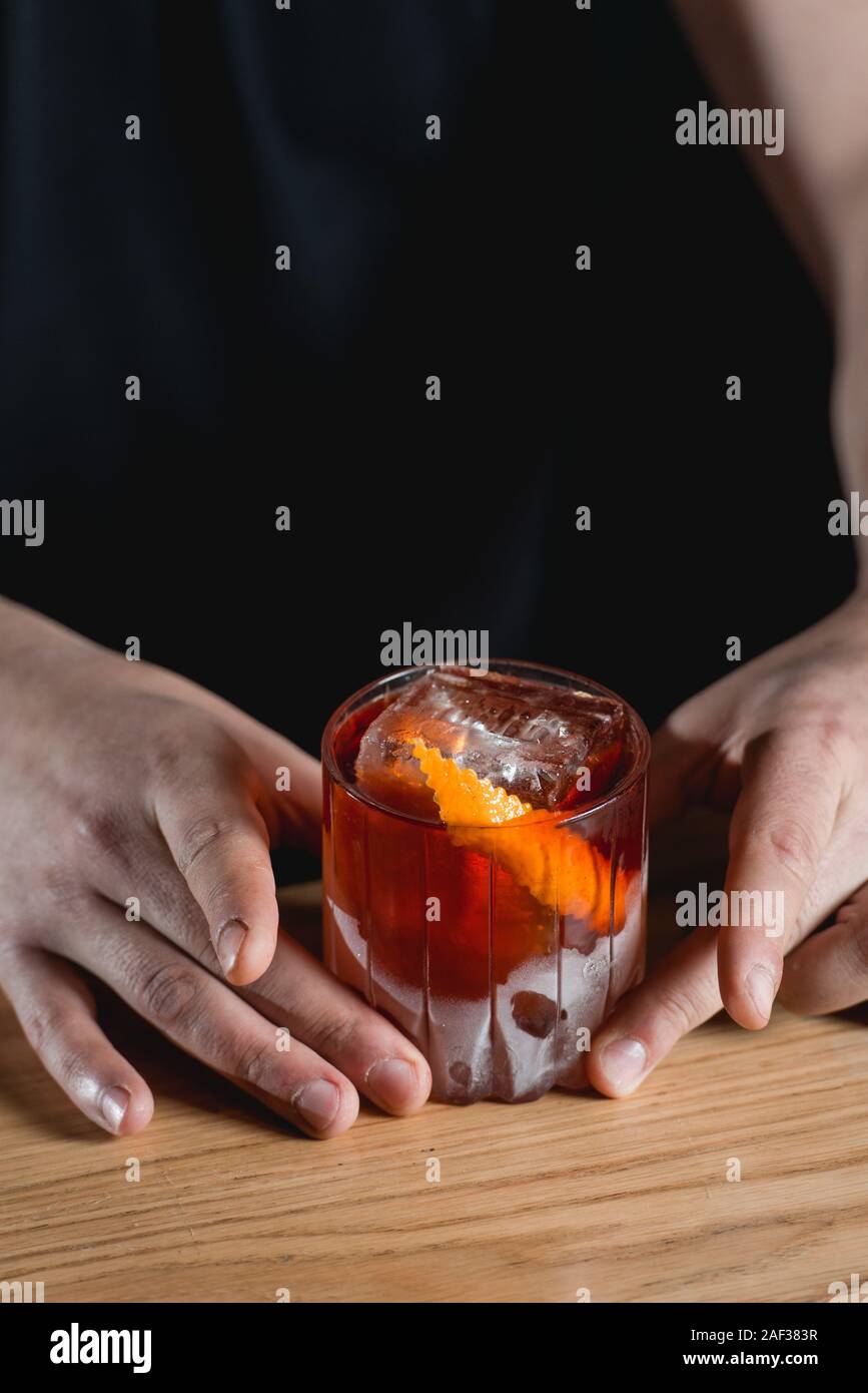Boulevardie cocktail on a bar desk. Black background Stock Photo - Alamy