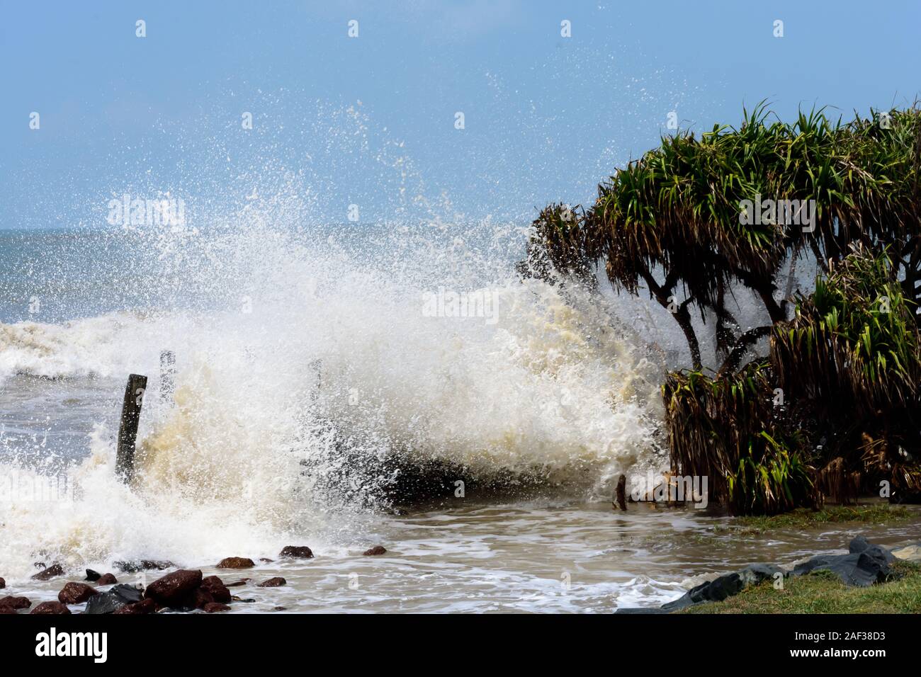 Big waves crushing on shore of a tropical island trees during a storm ...