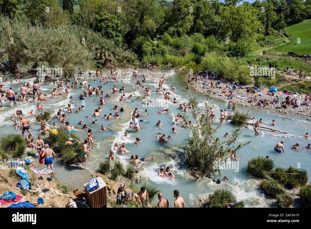 Many people are relaxing in the white cascades filled with sulphurous ...