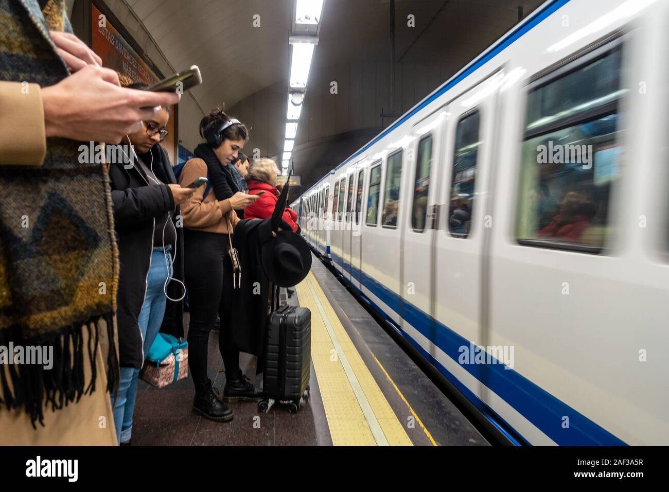 People using phones train hi-res stock photography and images - Alamy