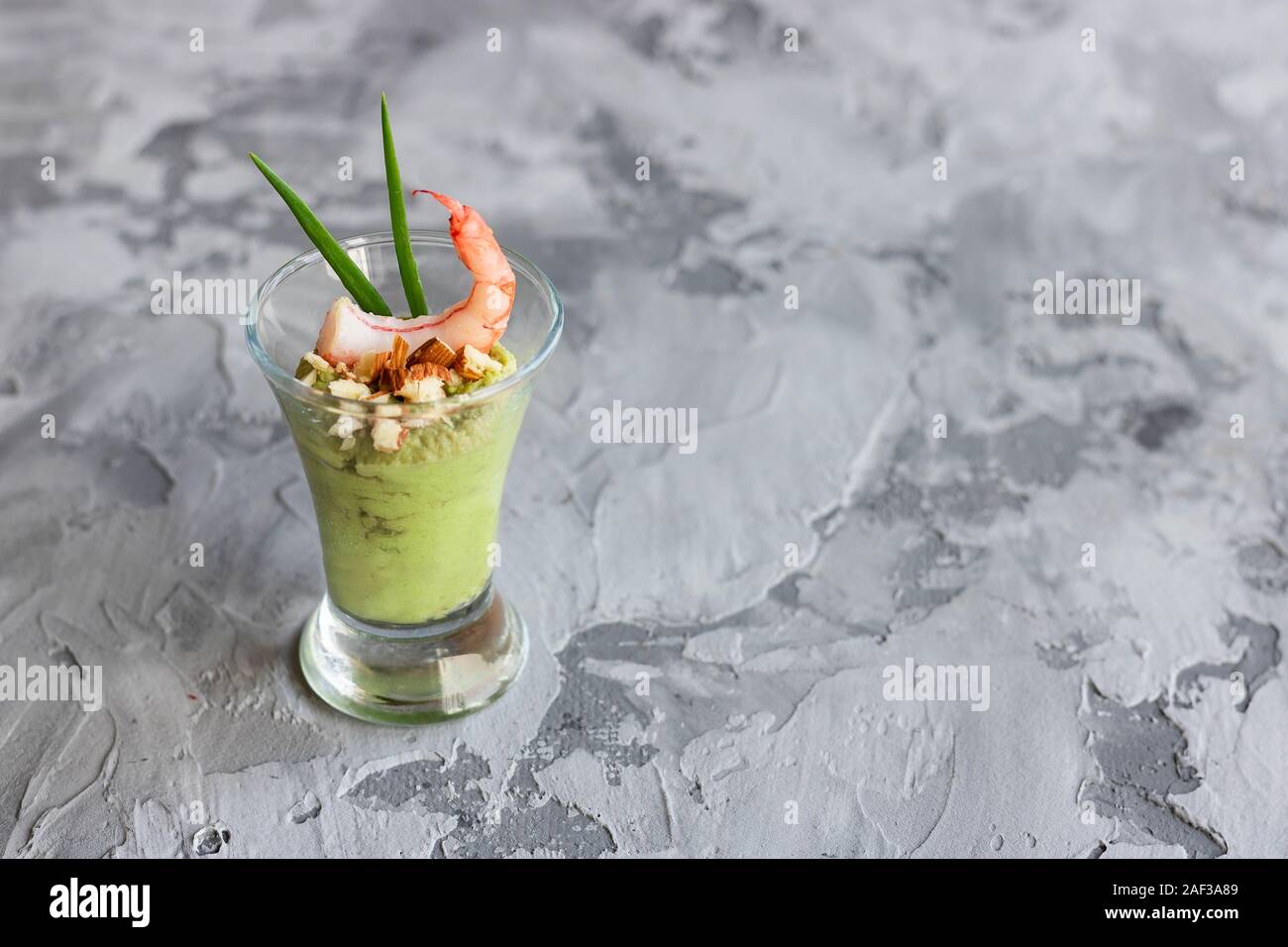 Avocado and green apple mousse with shrimp and almonds. Portion ...