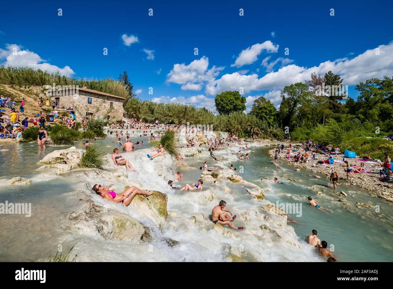 Many people are relaxing in the white cascades filled with sulphurous ...