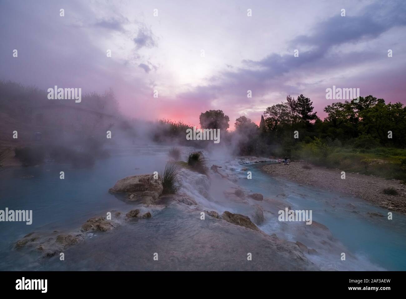 Steam of the sulphurous water ascents over the white cascades of the ...