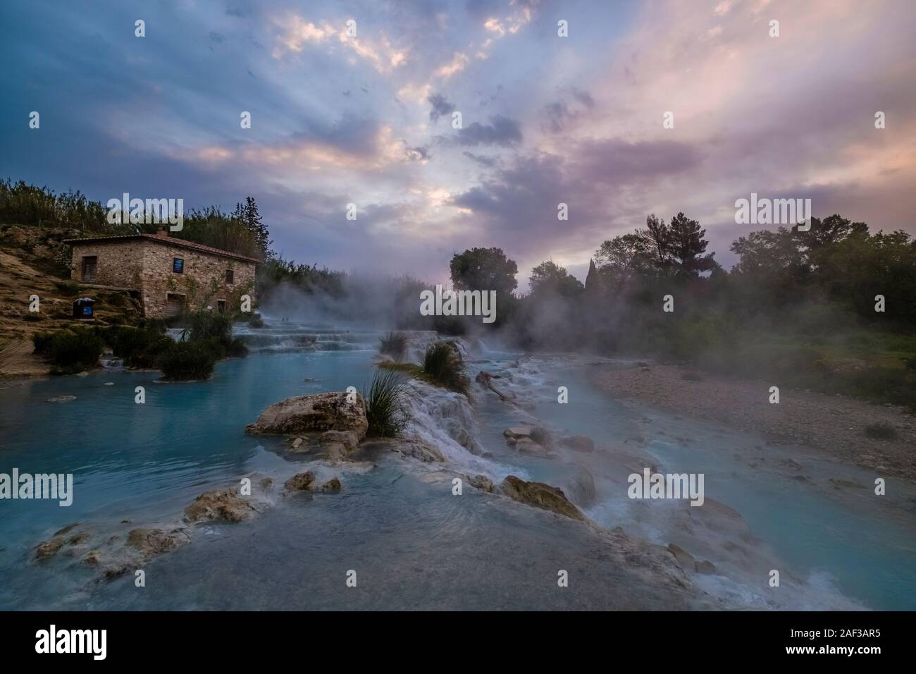 Steam of the sulphurous water ascents over the white cascades of the ...
