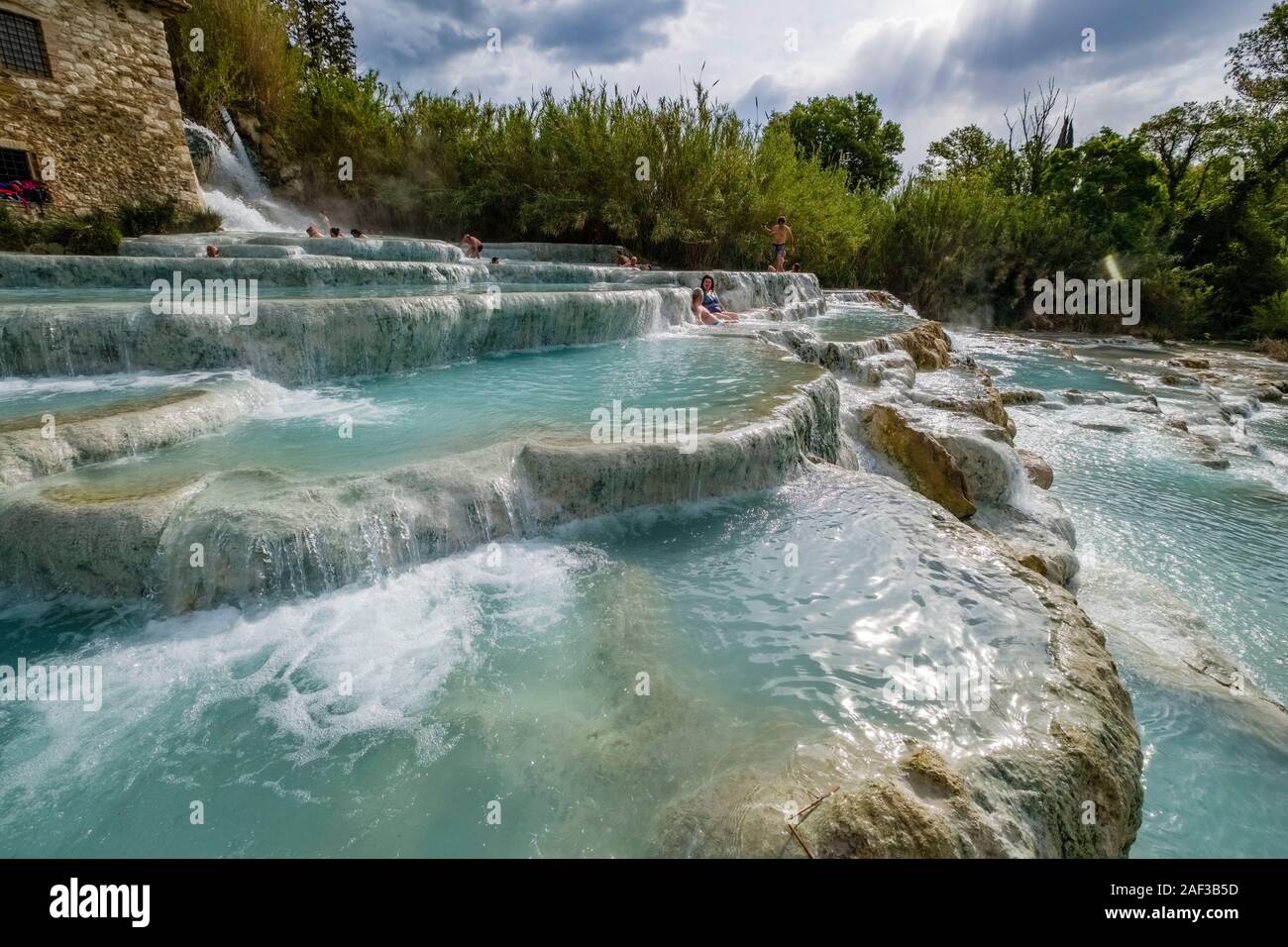 The sulphurous water is flowing over the white cascades of the thermal ...