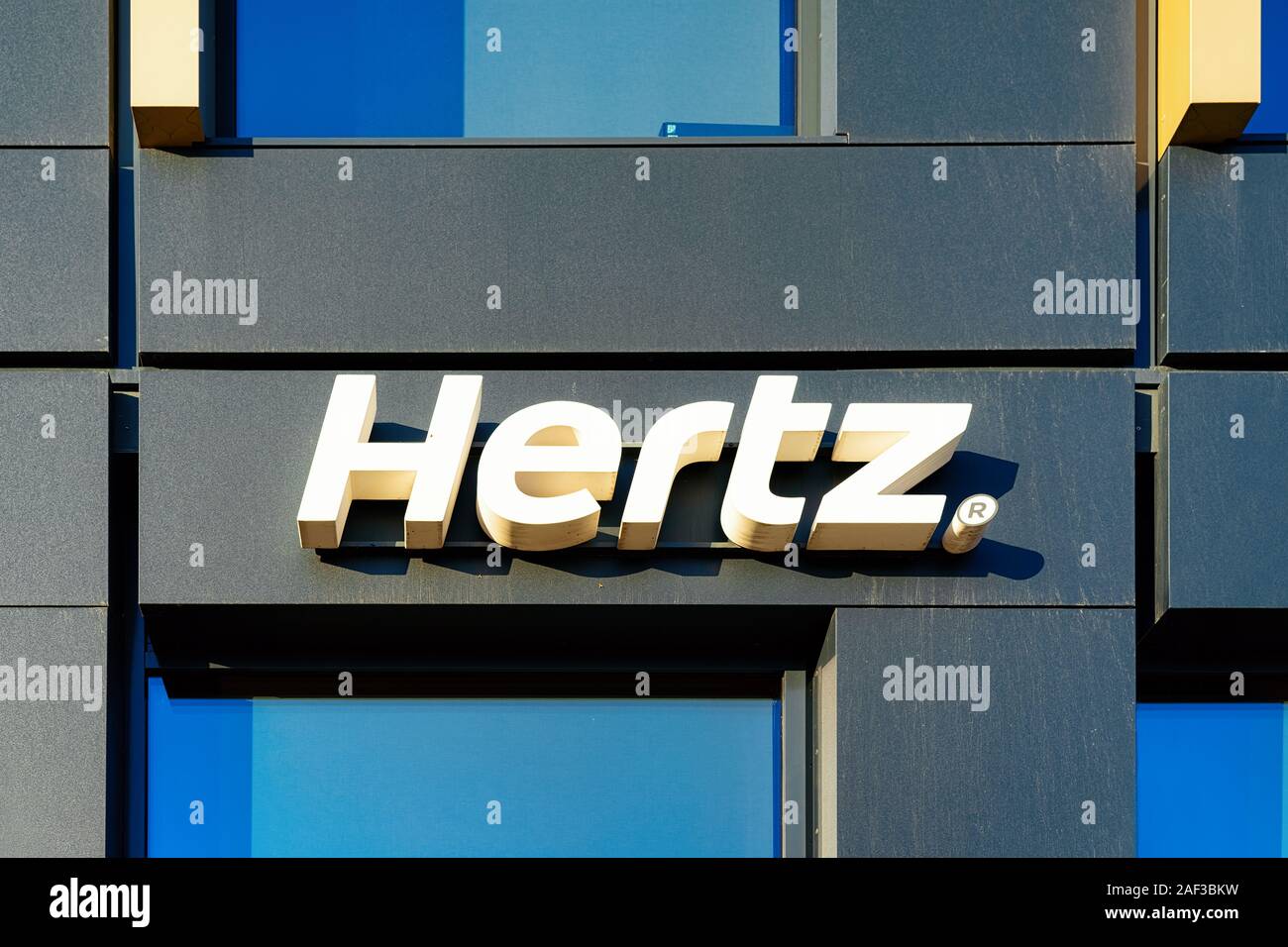 Hertz logo on modern business office building Stock Photo - Alamy