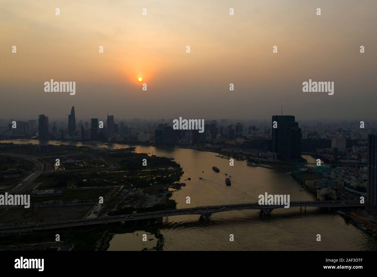 Saigon river sunset with extreme air pollution. Beautiful orange, red ...