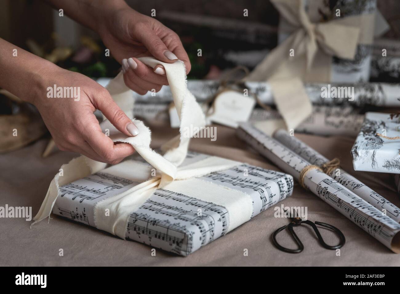 Hands wrapping stylish gift box Stock Photo - Alamy