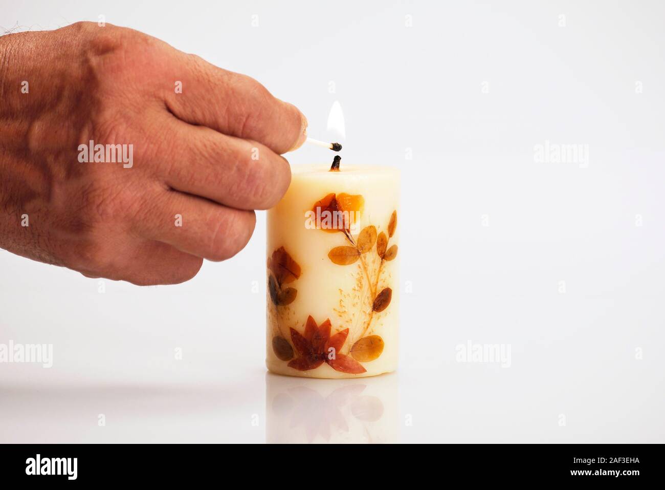 MAN LIGHTING A CANDLE Stock Photo - Alamy