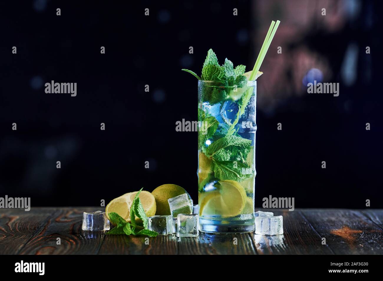 Bright green color. Cocktail is ready. On the wooden table in the night ...