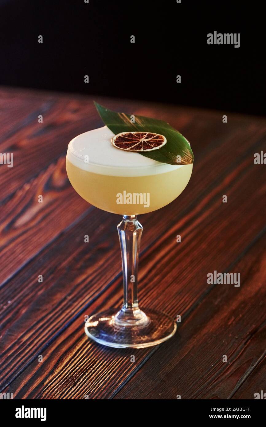 Hope you like it. Cocktail is ready. On the wooden table in the night ...
