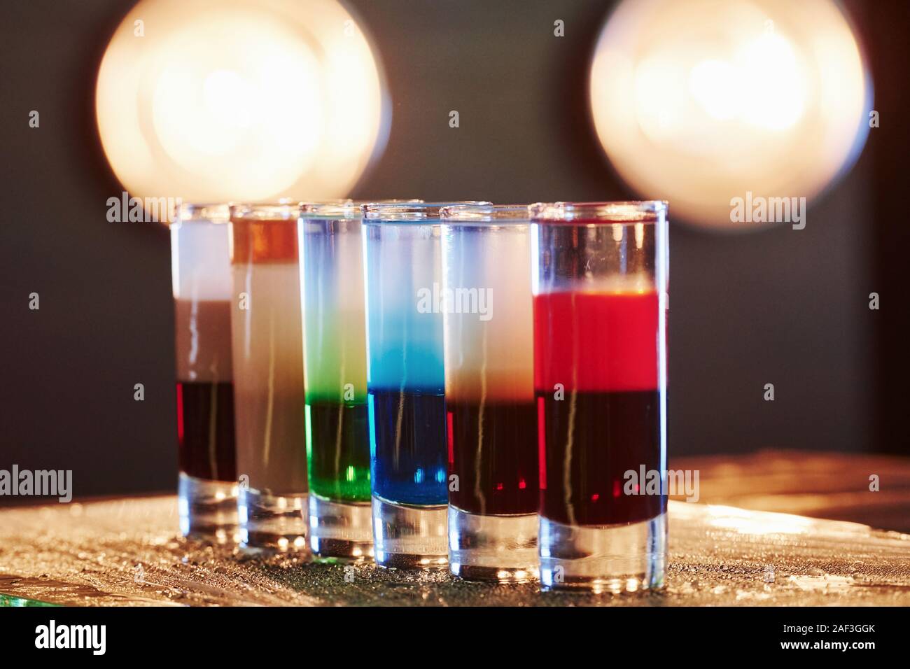 Six shots. Cocktails is ready. On the wooden table in the night club ...