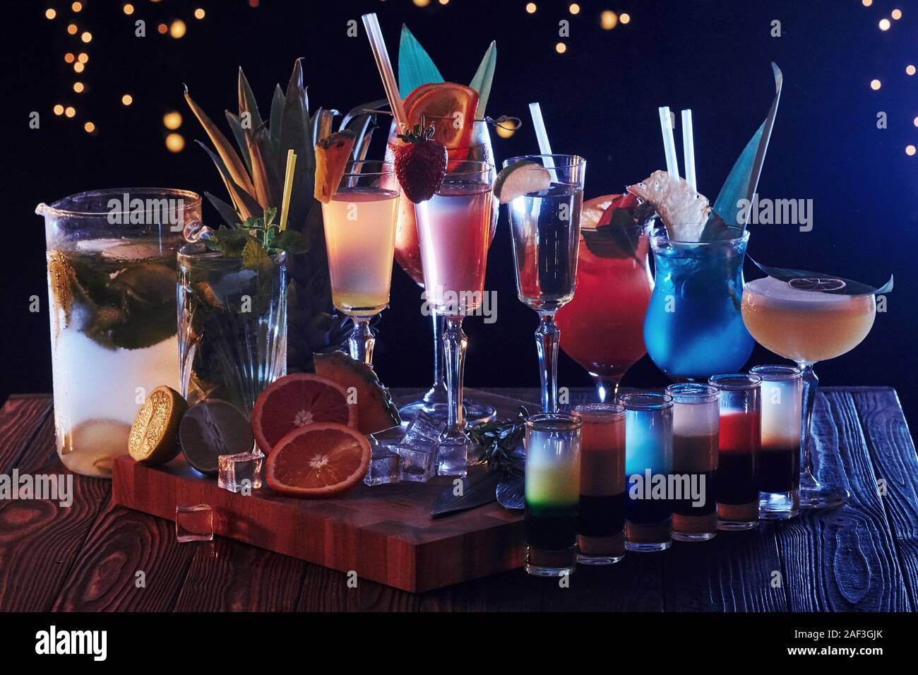 Variety of alcoholic drinks. Cocktails is ready. On the wooden table in ...