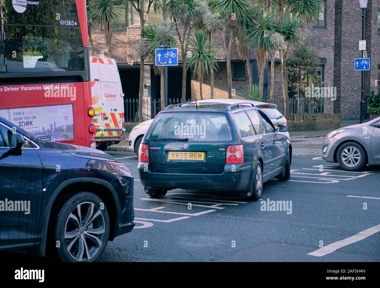 Turning car cutting into traffic at intersection in traffic jam London ...