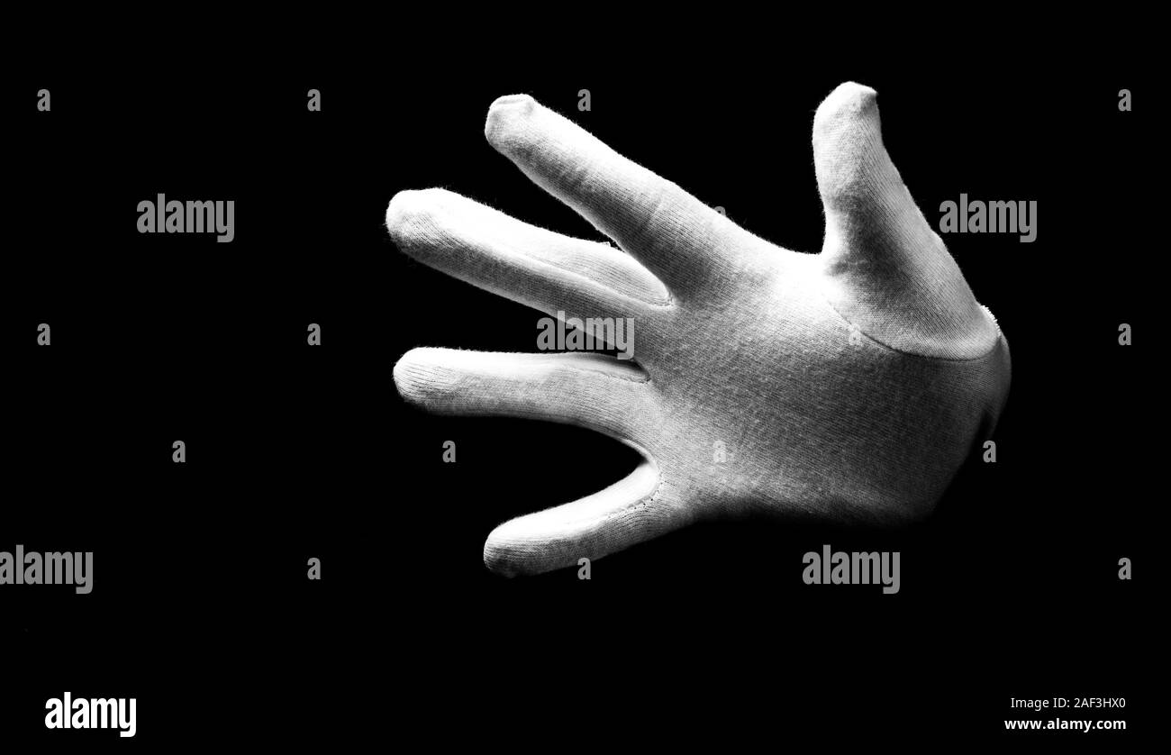 Number five 5 - a male hand wearing white glove isolated on black ...