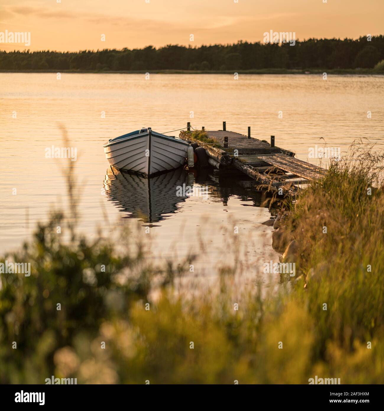Boat at a jetty at sunset, Gotland, Sweden, Scandinavia Stock Photo - Alamy