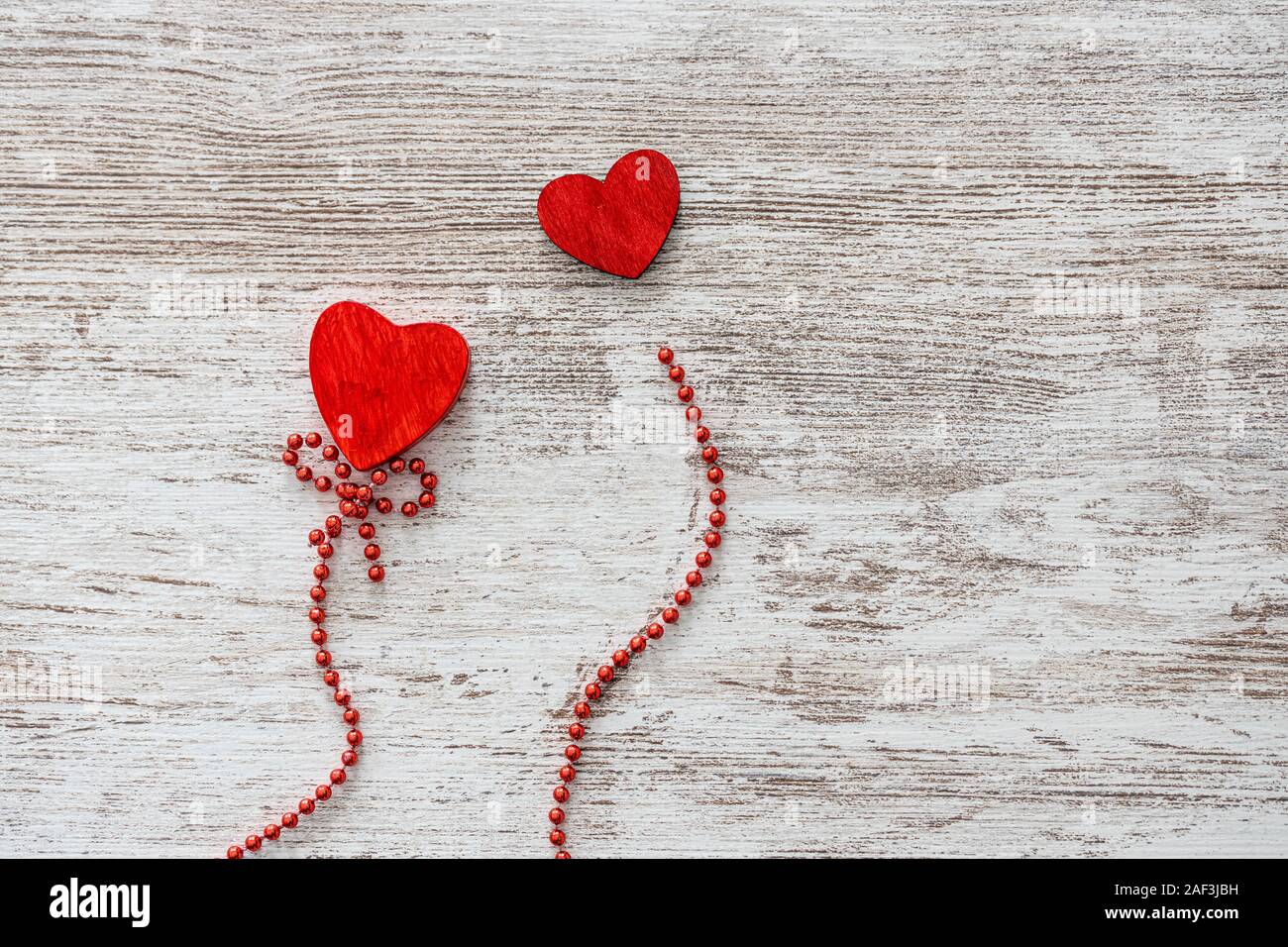 Two red balloons. One separates from the other Stock Photo - Alamy