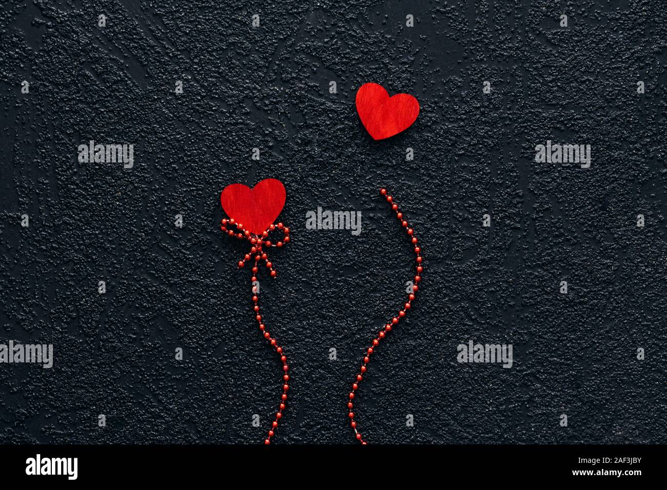Two red balloons. One separates from the other Stock Photo - Alamy