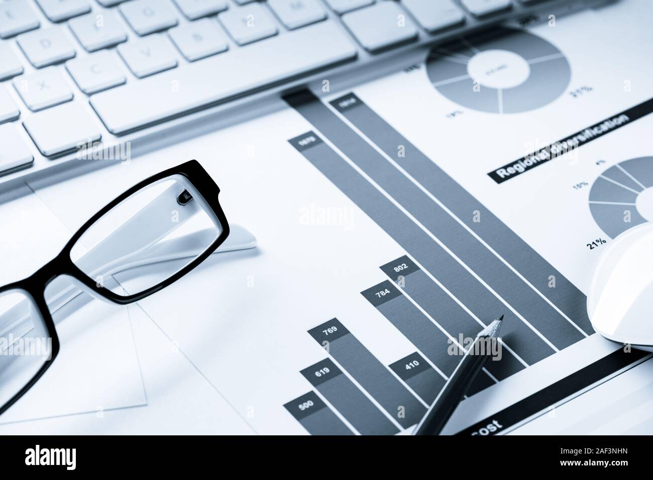 Business workplace with keyboard mouse and papers with graphs and ...